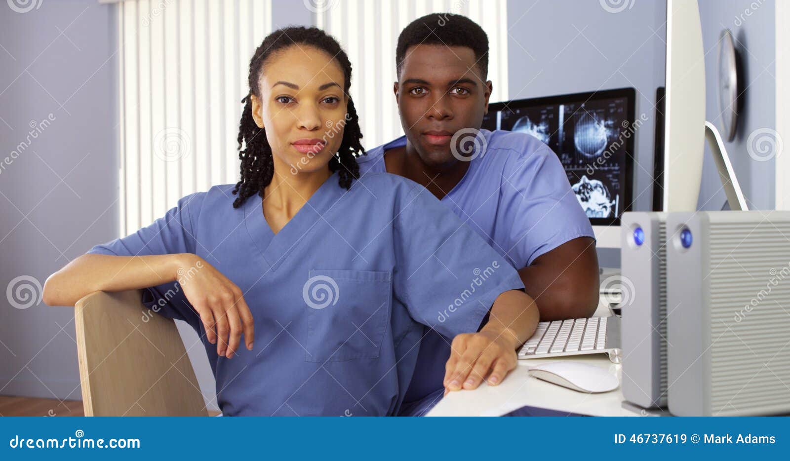 Black Nurses in Nurses Station Sitting at Computer Stock Image - Image ...