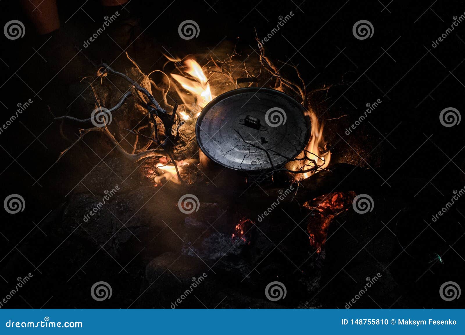 Black Pan with a Cover Standing on the Bonfire in the Night Stock Photo ...