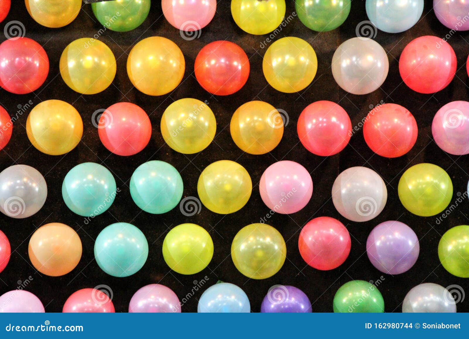 Black Panel with Colored Balloons in a Row in a Fair Stock Photo ...