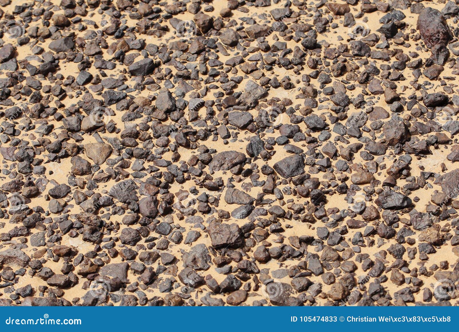 Black pebbles in a desert stock image. Image of pattern - 105474833