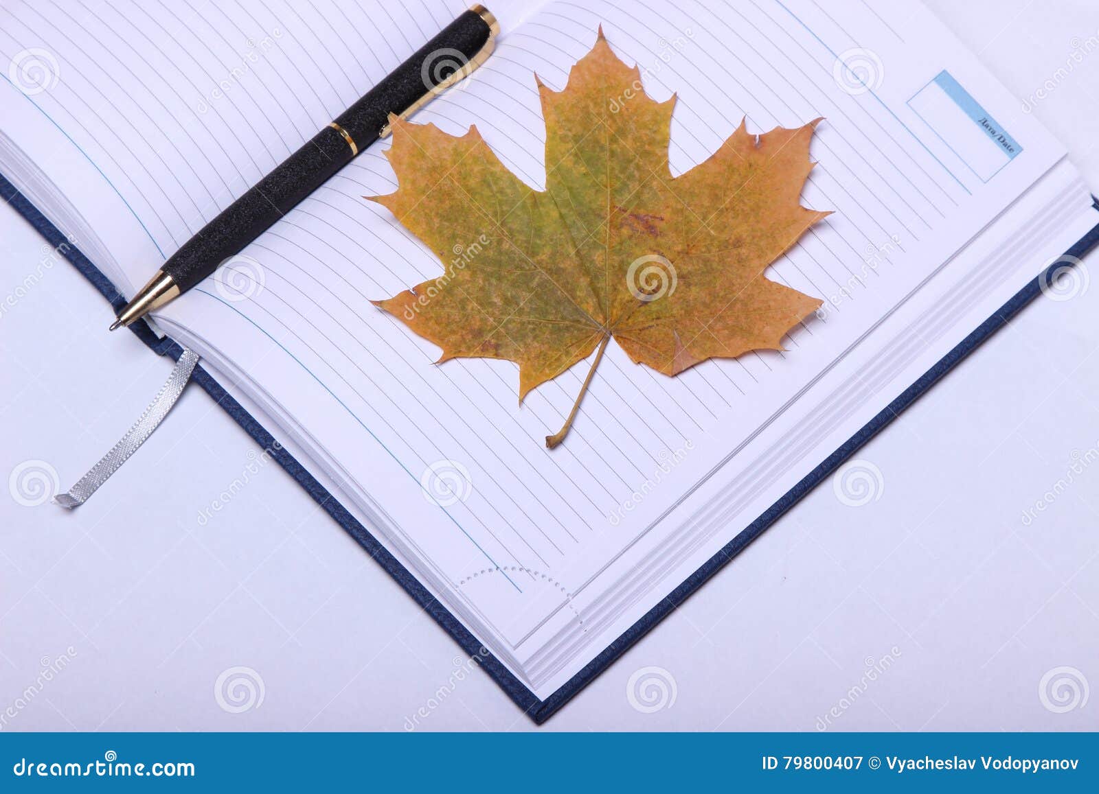 Black Pen Lying on a Notebook. Yellow Maple Leaf Stock Image - Image of ...