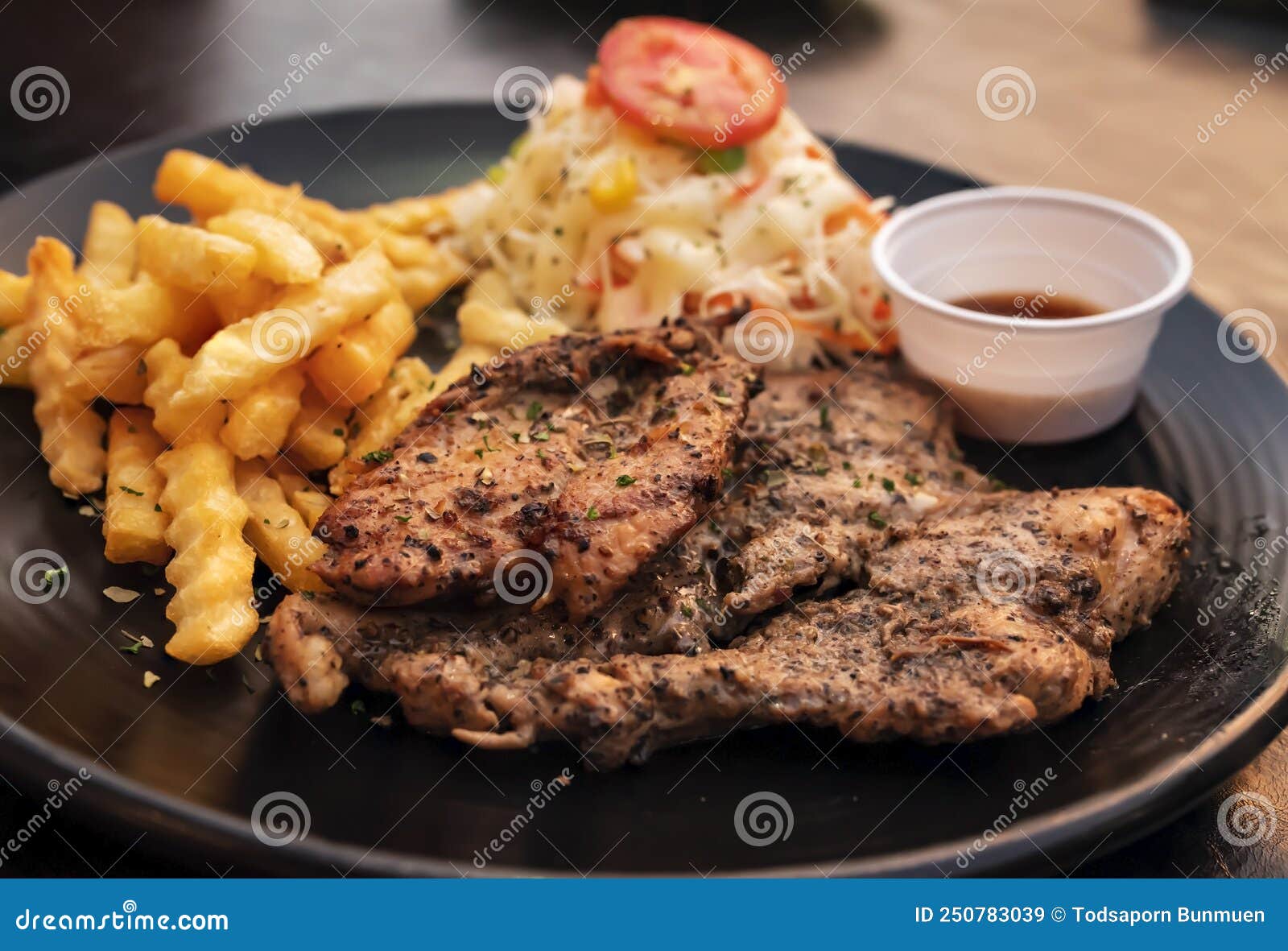 Black Pepper Marinated Chicken Fillet with Potato Sticks on a Black ...