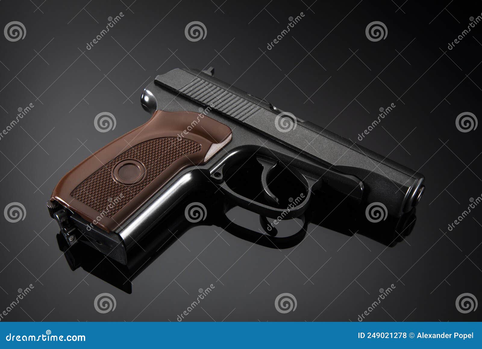 Black Pistol with a Brown Handle on a Gray Gradient Background Stock ...