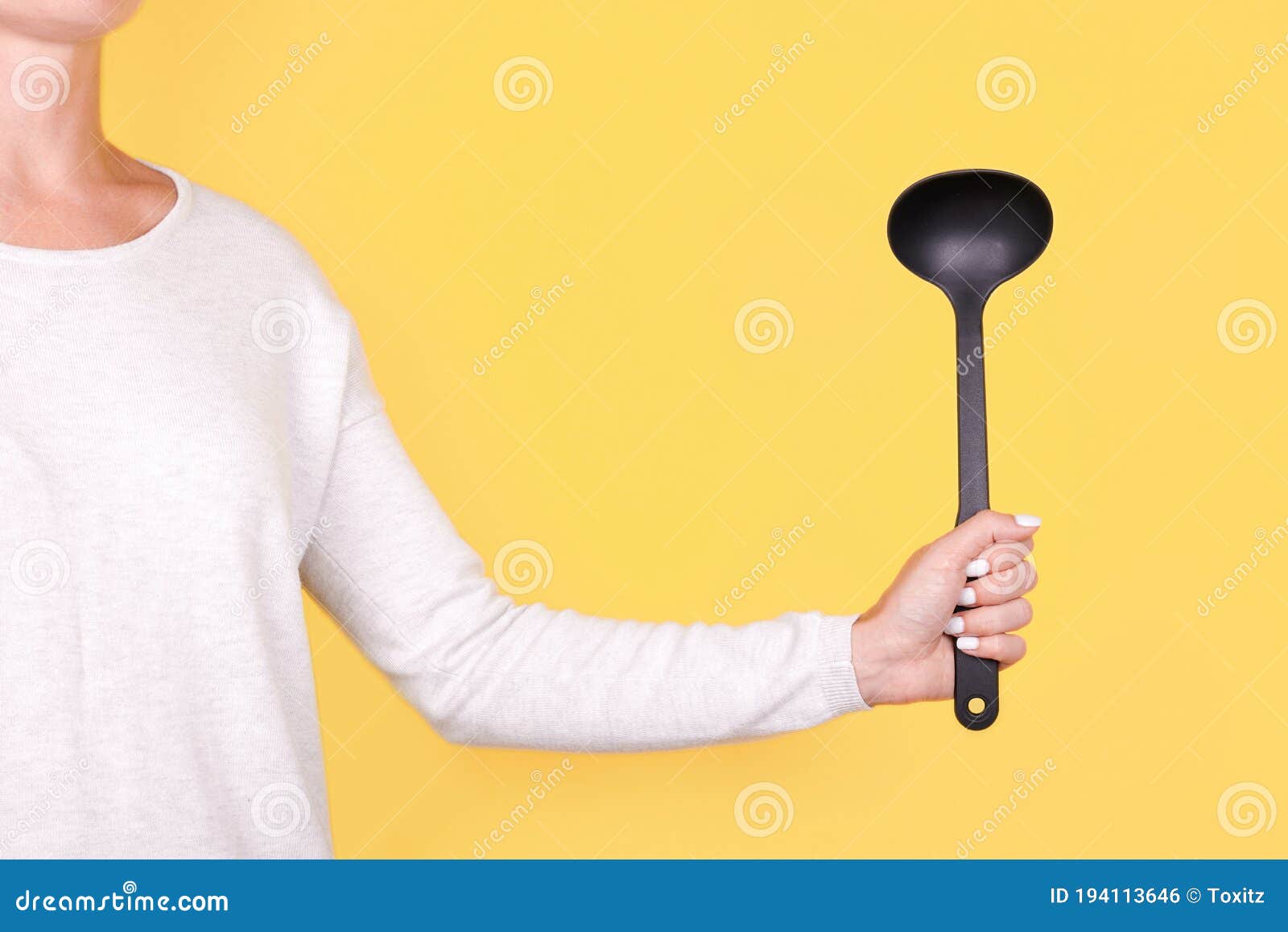 Black Plasic Ladle in Hand, Isolated on Yellow Background Stock Photo ...