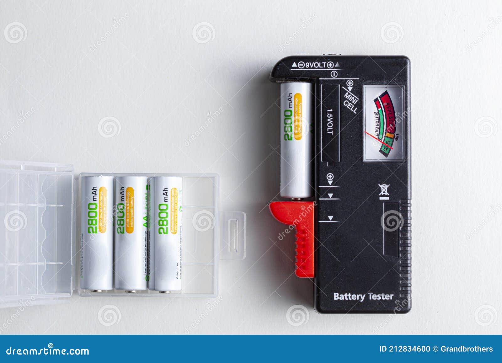 A Black Plastic Battery Tester with a Clamp on the Side that Different ...