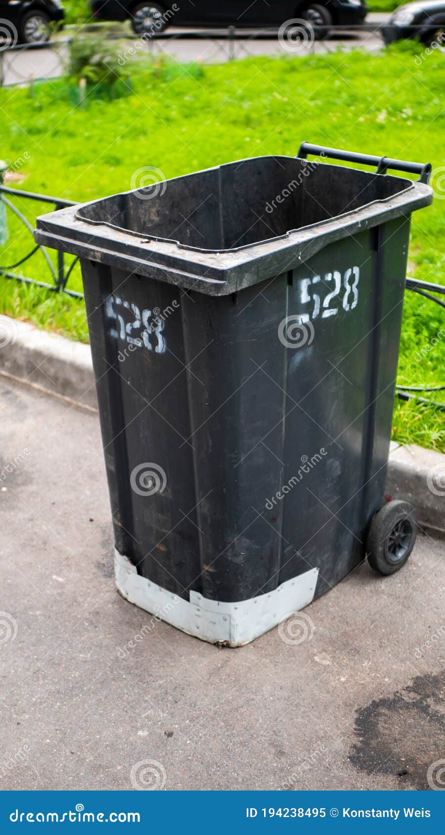 Black Plastic Garbage Collection Container on the Street with the Lid ...