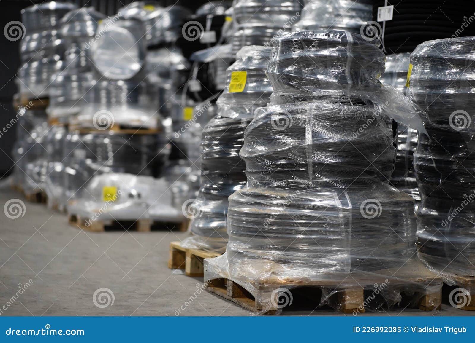 Black Plastic Pipes Wrapped in Foil on a Pallet in a Warehouse. Stock ...