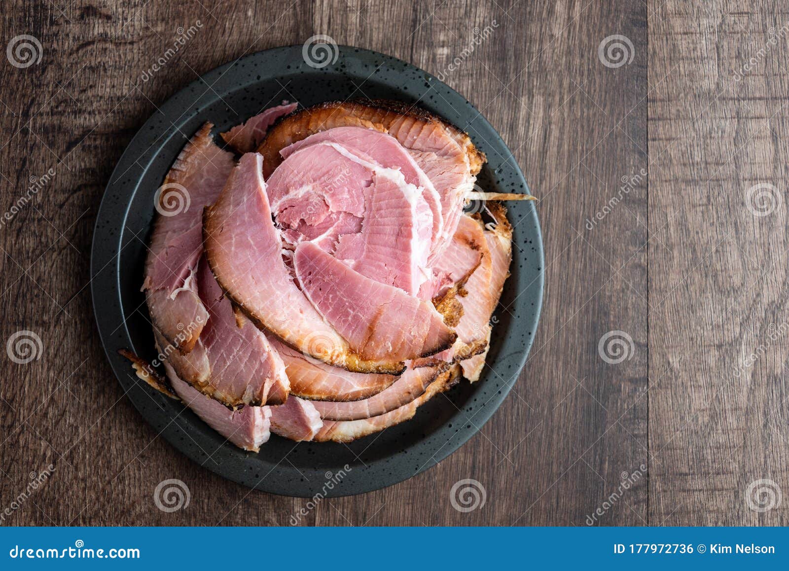 Black Plate Stacked with Sliced Ham on a Wood Table Stock Photo - Image ...