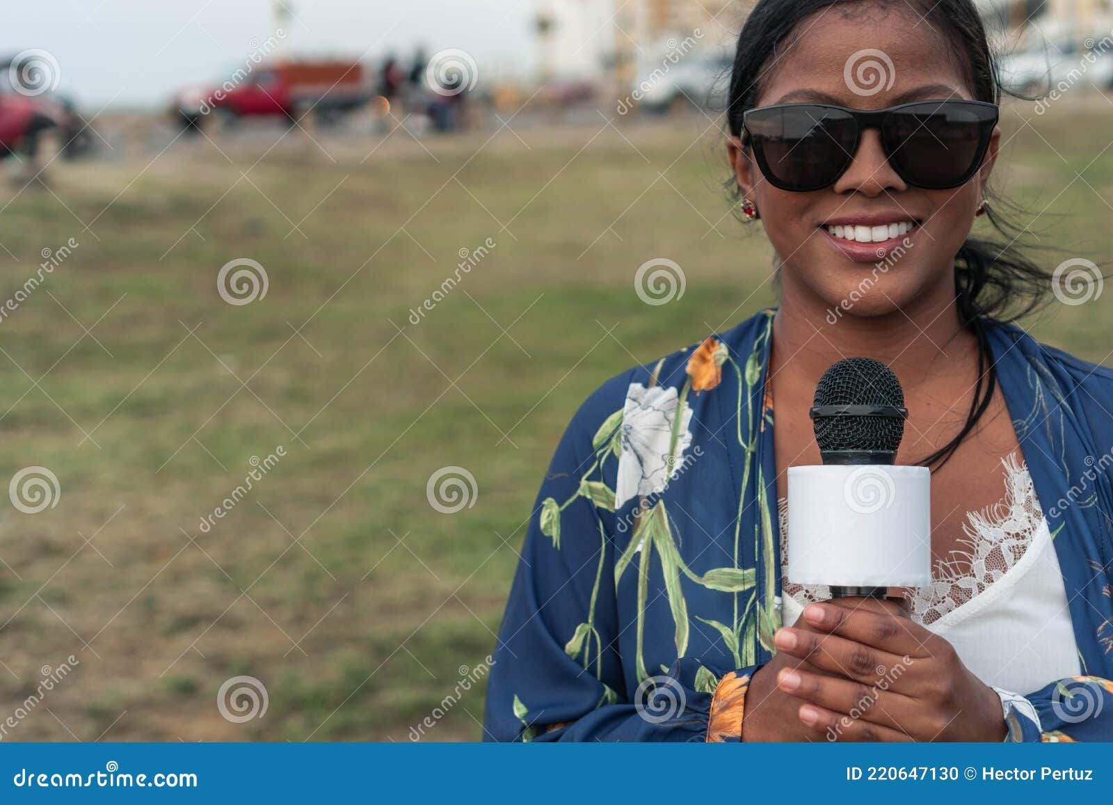 Black Presenter Speaking into Microphone while Standing in the City ...