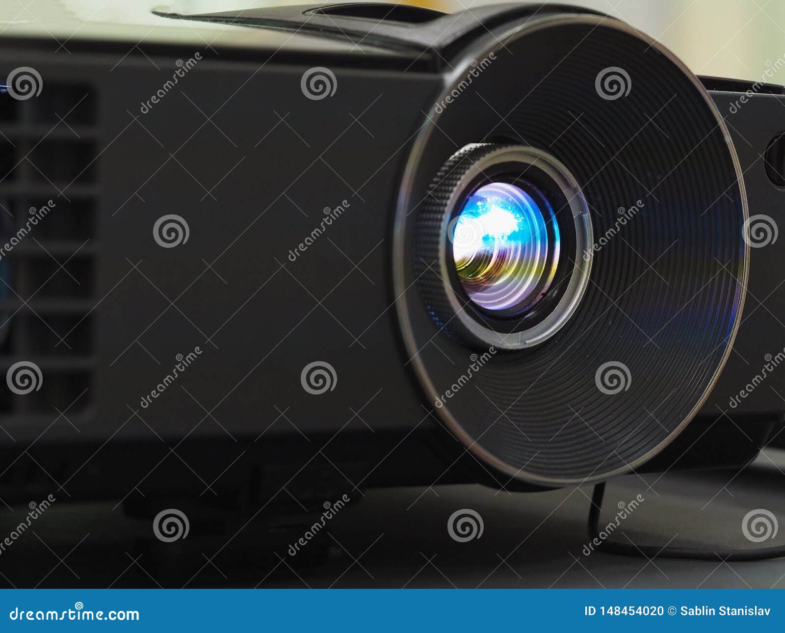 Black Projector With Tripod Installed On White Table, In Hall Or ...