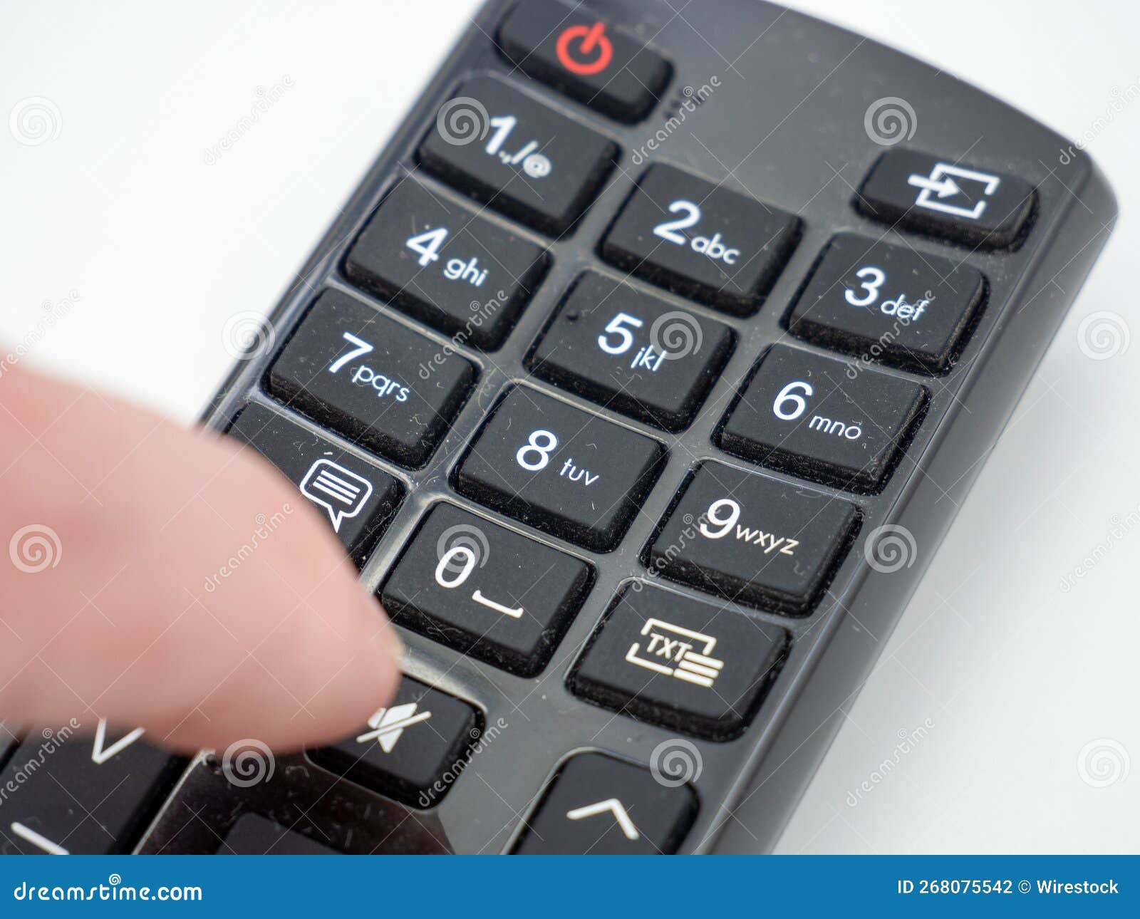 Black Remote Control Isolated on a White Background with a Finger ...