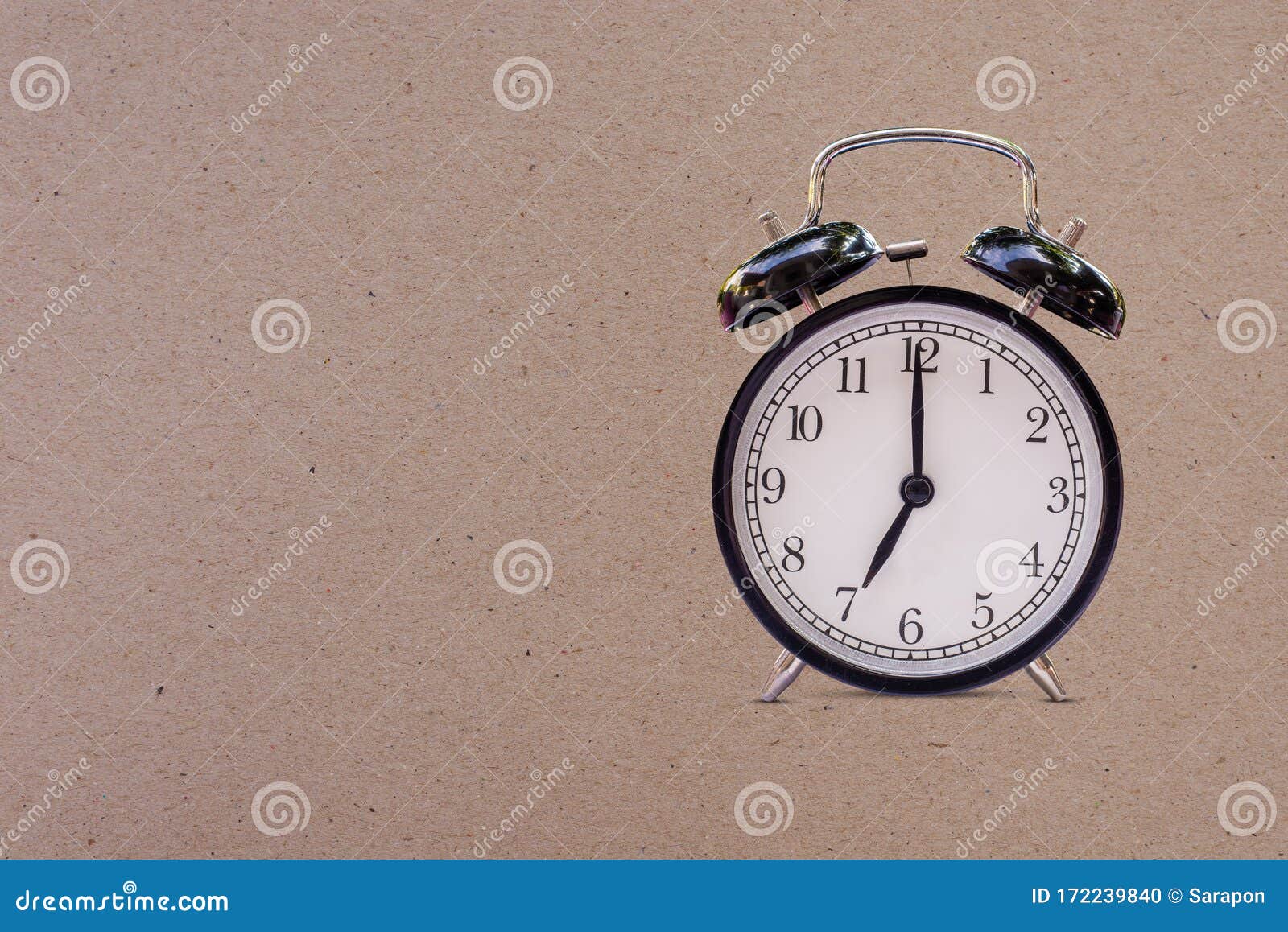 Black Retro Alarm Clock at 07:00 O`clock on Brown Old Paper with Space ...