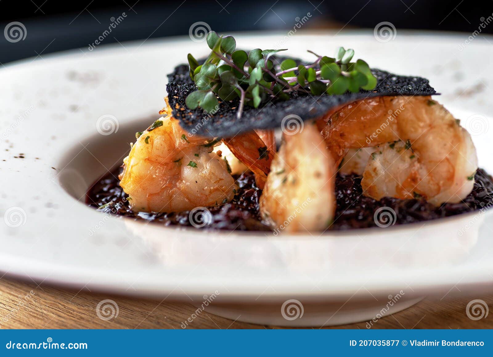 Black Rice Risotto. Shrimp Risotto on a White Plate on the Table ...