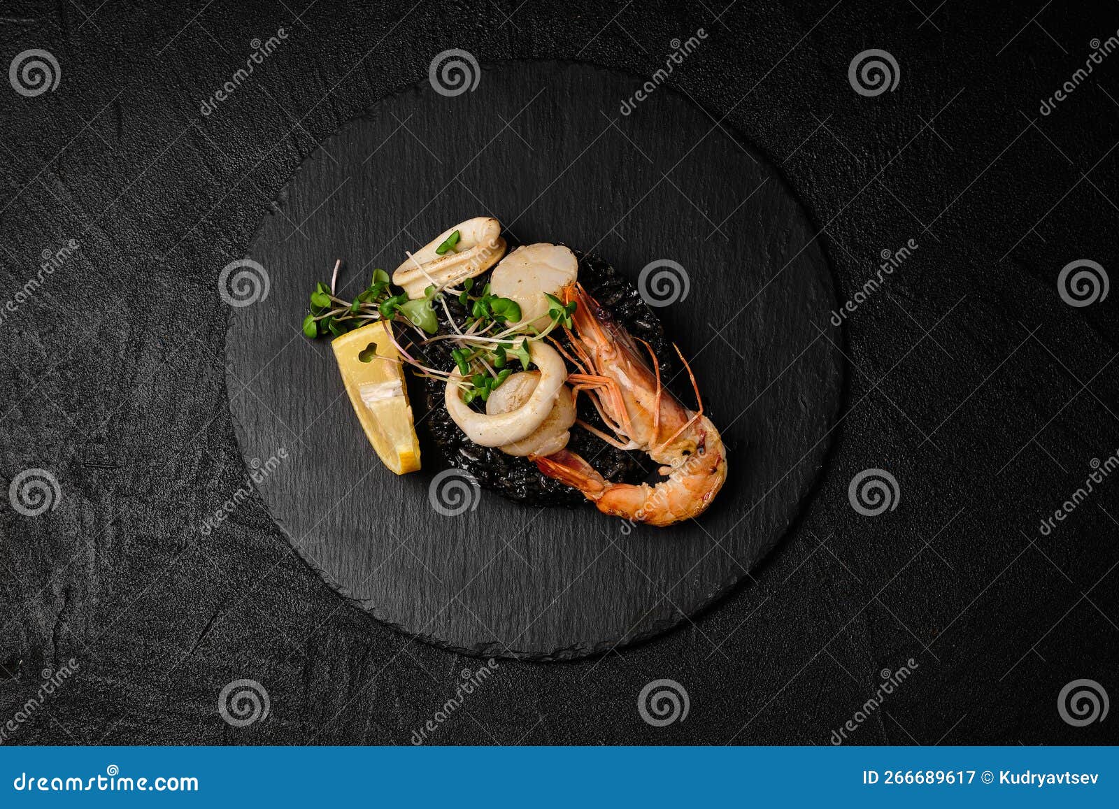 Black Risotto with Crayfish, Squid Rings and Scallop on a Black Plate ...