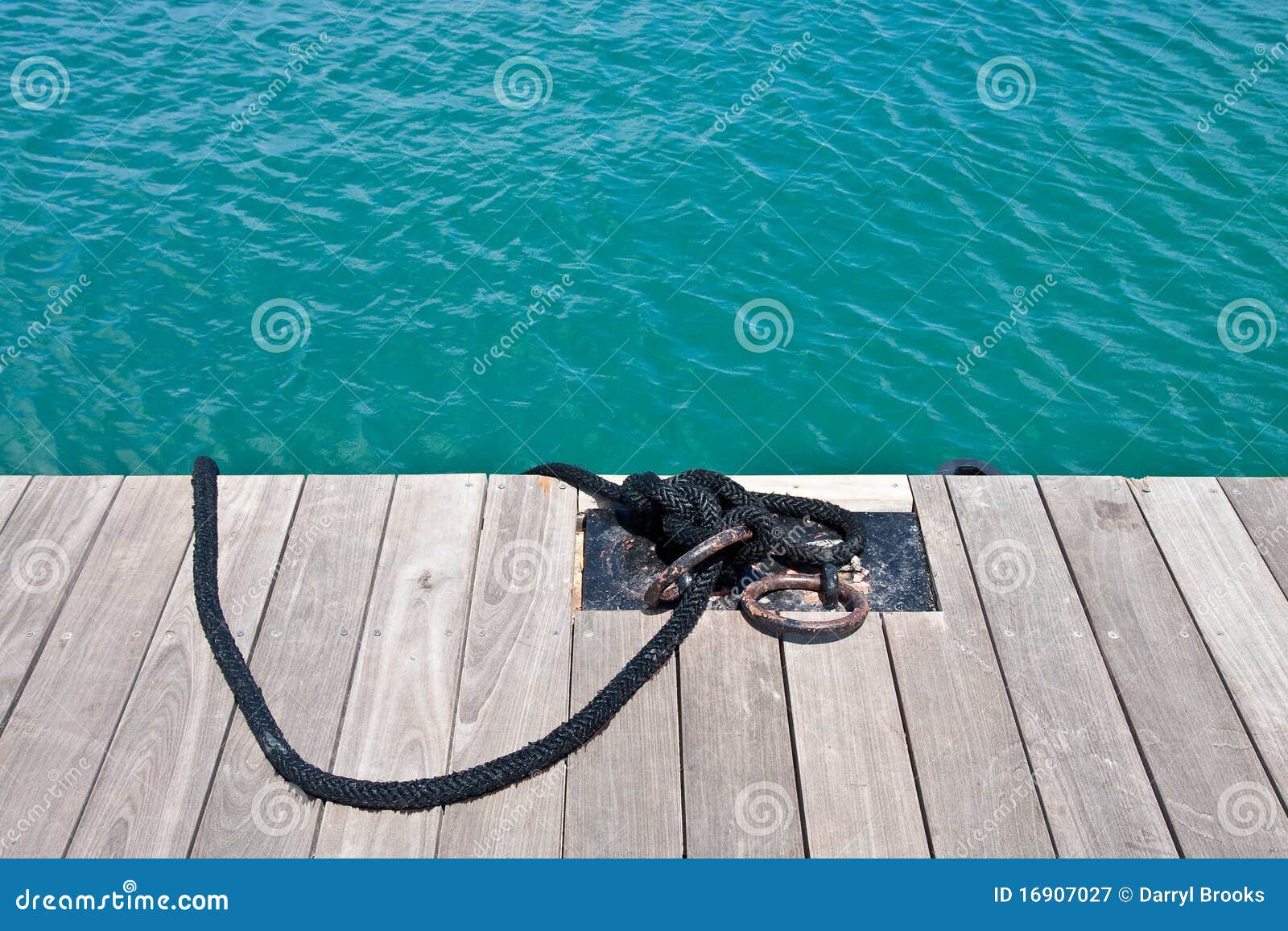 Black Rope Tied To Iron Rings on Edge of a Dock Stock Image - Image of ...