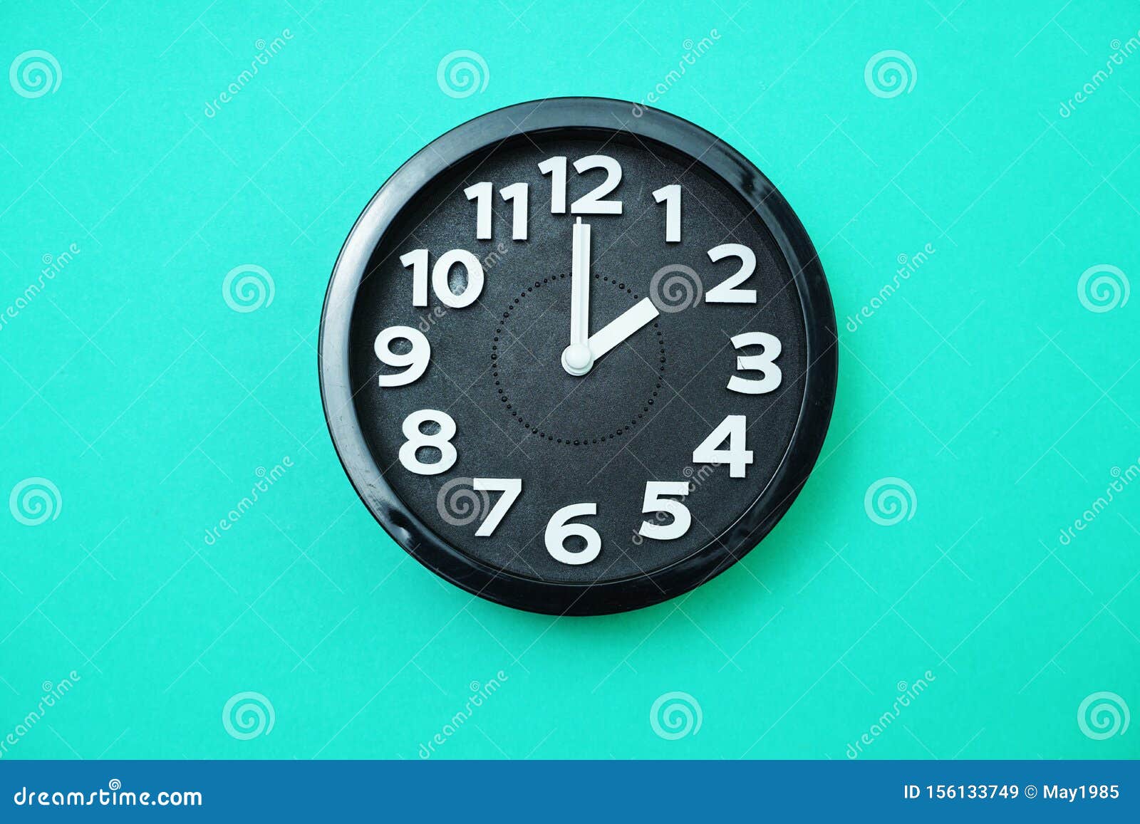 Black Round Clock Showing Two O`clock on Green Background Stock Image ...