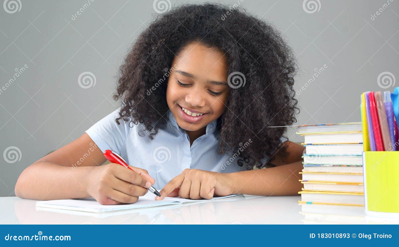 Black School Girl Writes in a Notebook, Doing Homework Stock Image ...