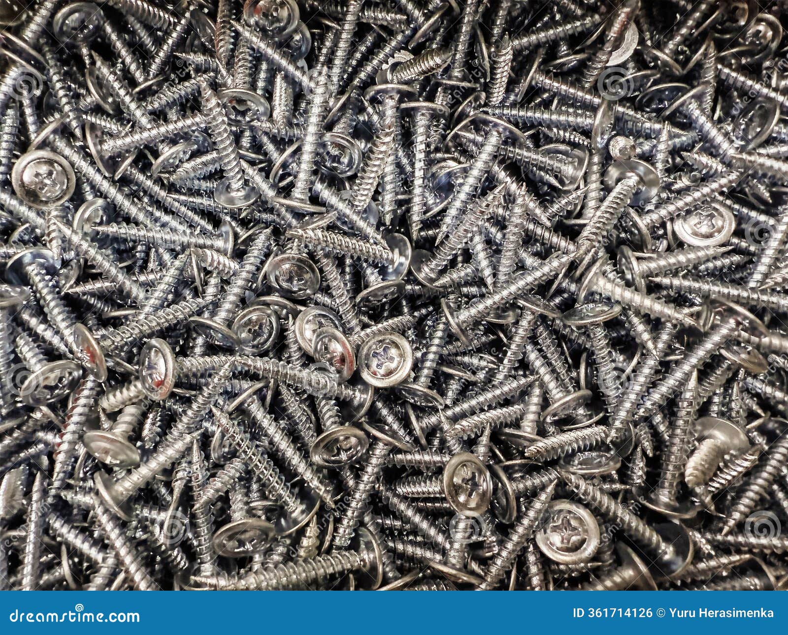 Black Screws Scattered in a Container Showcasing Various Sizes and ...