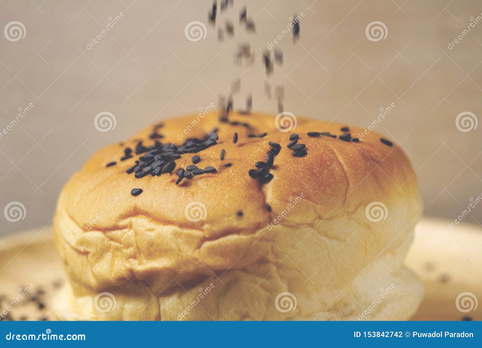 Black Sesame Seeds Falling into Burger Bun Stock Photo - Image of bread ...