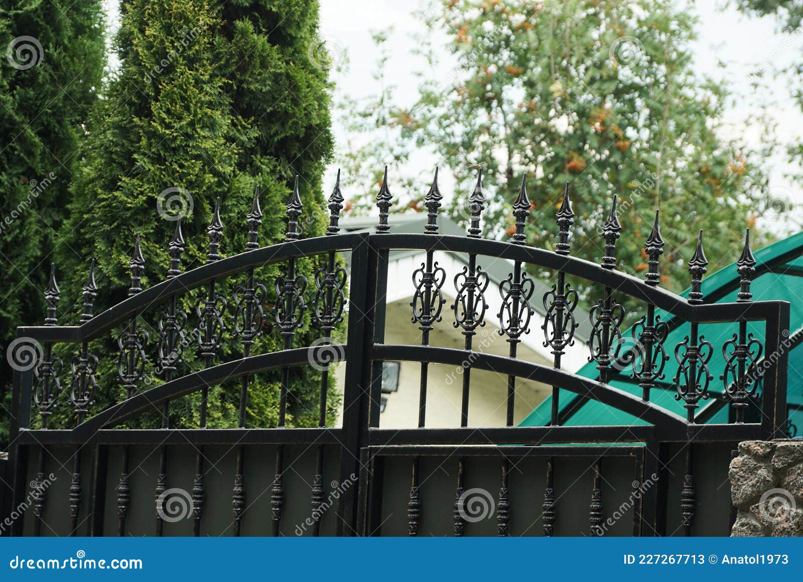 Black Sharp Iron Bars on a Metal Gate and a Wall on the Street Stock ...