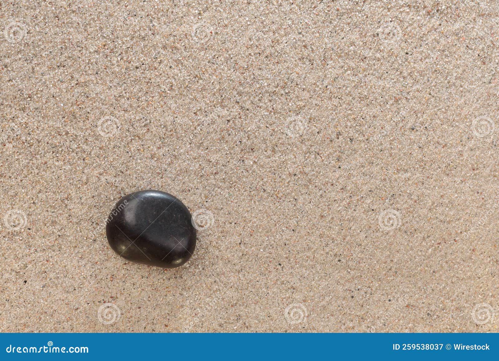 Black Shiny Stone in the Sand Stock Image - Image of beach, texture ...