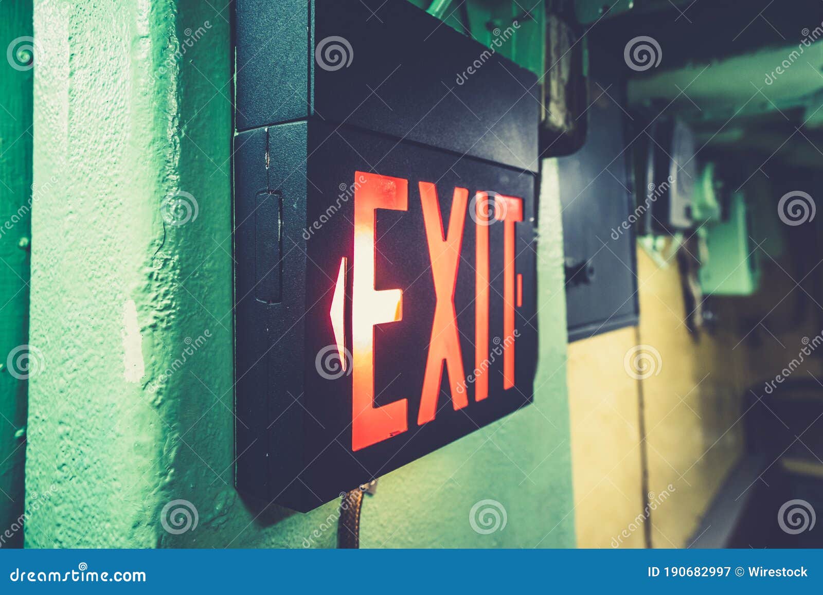 Black Sign with Red Light with [EXIT] Written on it on the Wall Stock ...