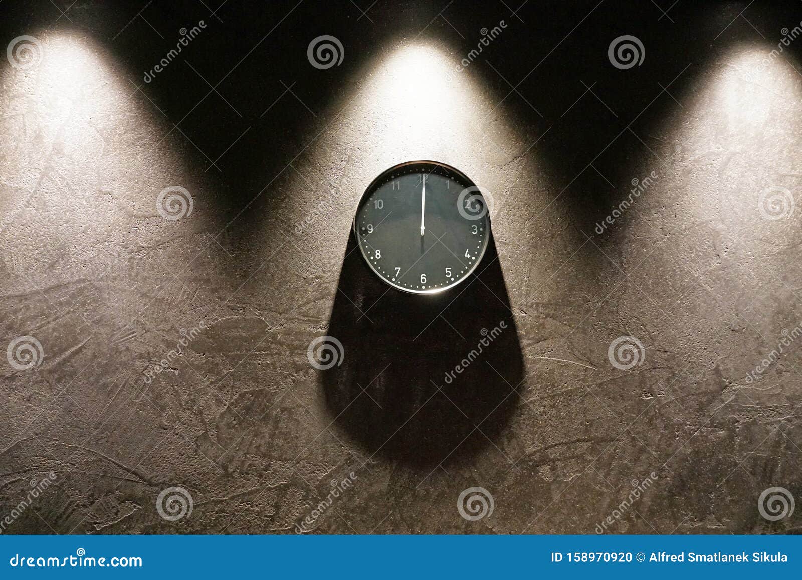 Black Simple Analog Clock Showing Midnight Hanging on the Wall with ...