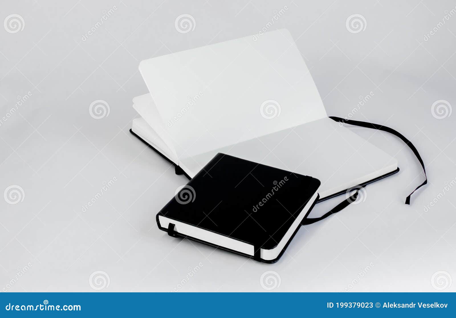 Black Small Closed Notepad and Large Open Notebook with Blank White ...