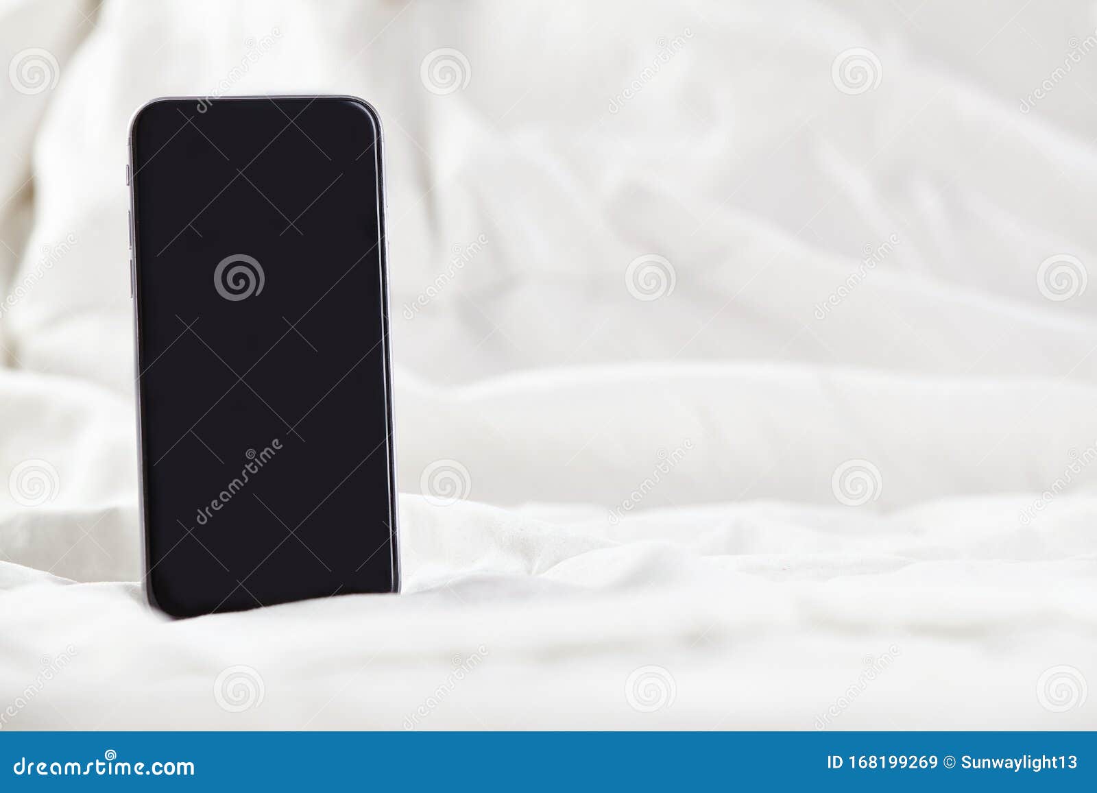 Black Smart Phone on White Bed in the Bedroom. Close Up Stock Image ...