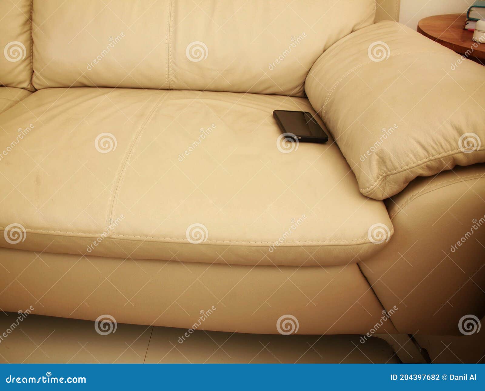 A Black Smartphone Lying on a Modern Beige Sofa Stock Photo - Image of ...