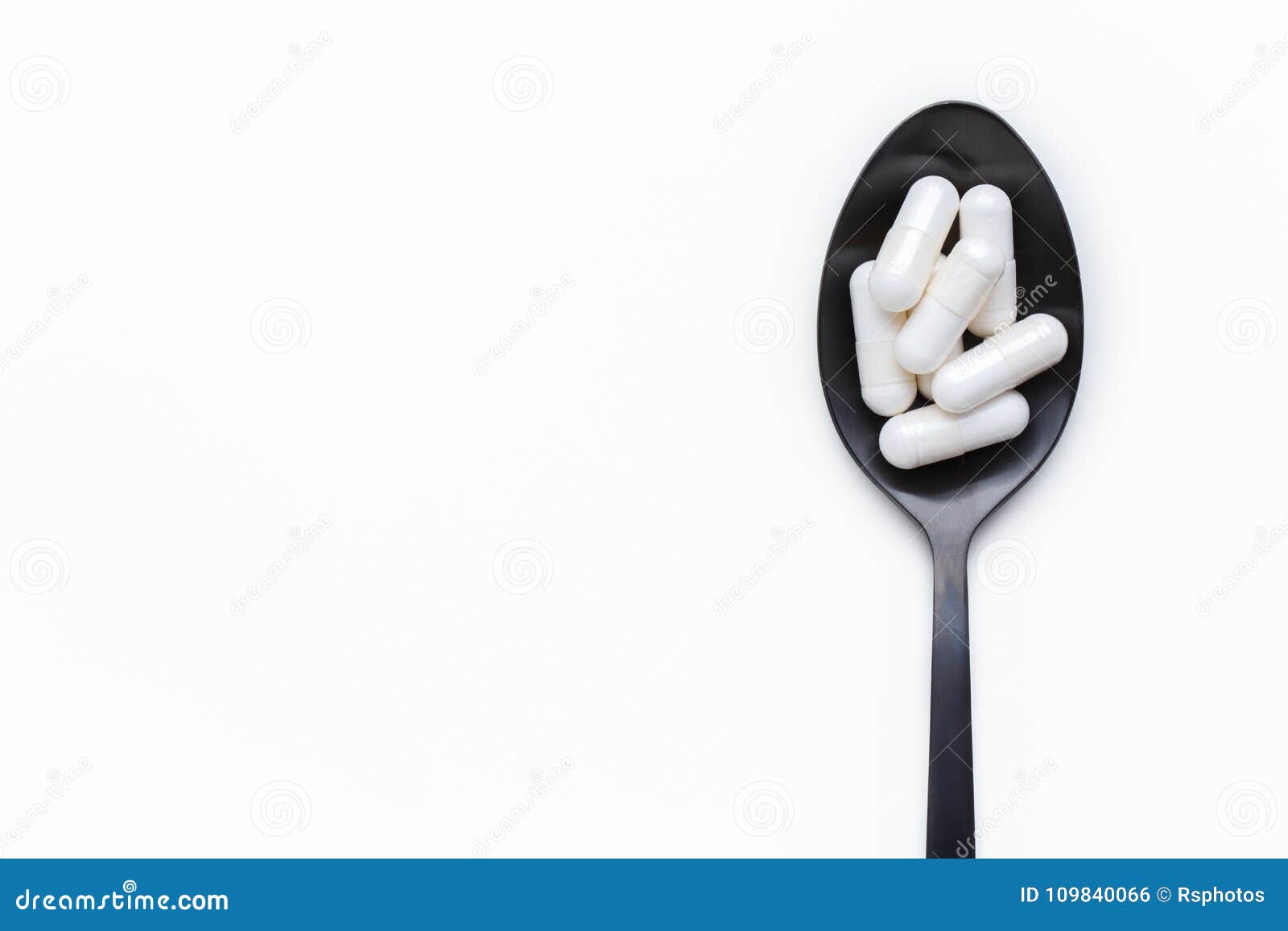 Capsules on Black Spoon Isolated Stock Photo - Image of dosage ...