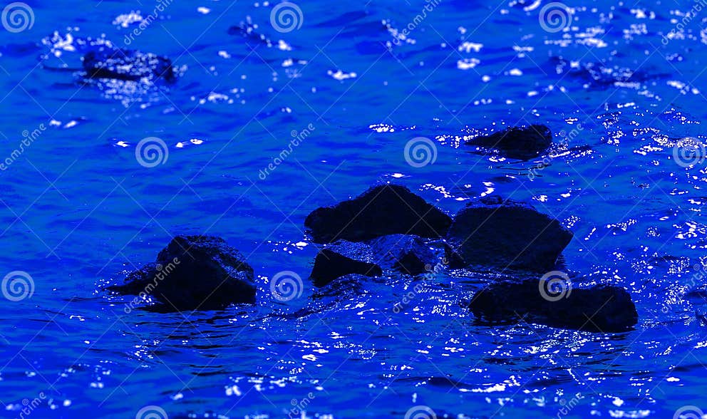 Black Stones in Deep Blue Water Stock Photo - Image of rock, background ...