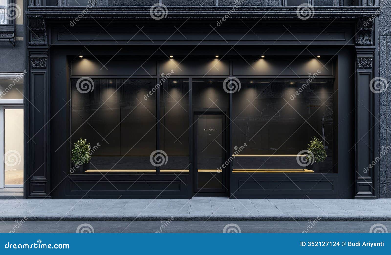 A Black Storefront with a Glass Door and Windows, Lit by Spotlights ...