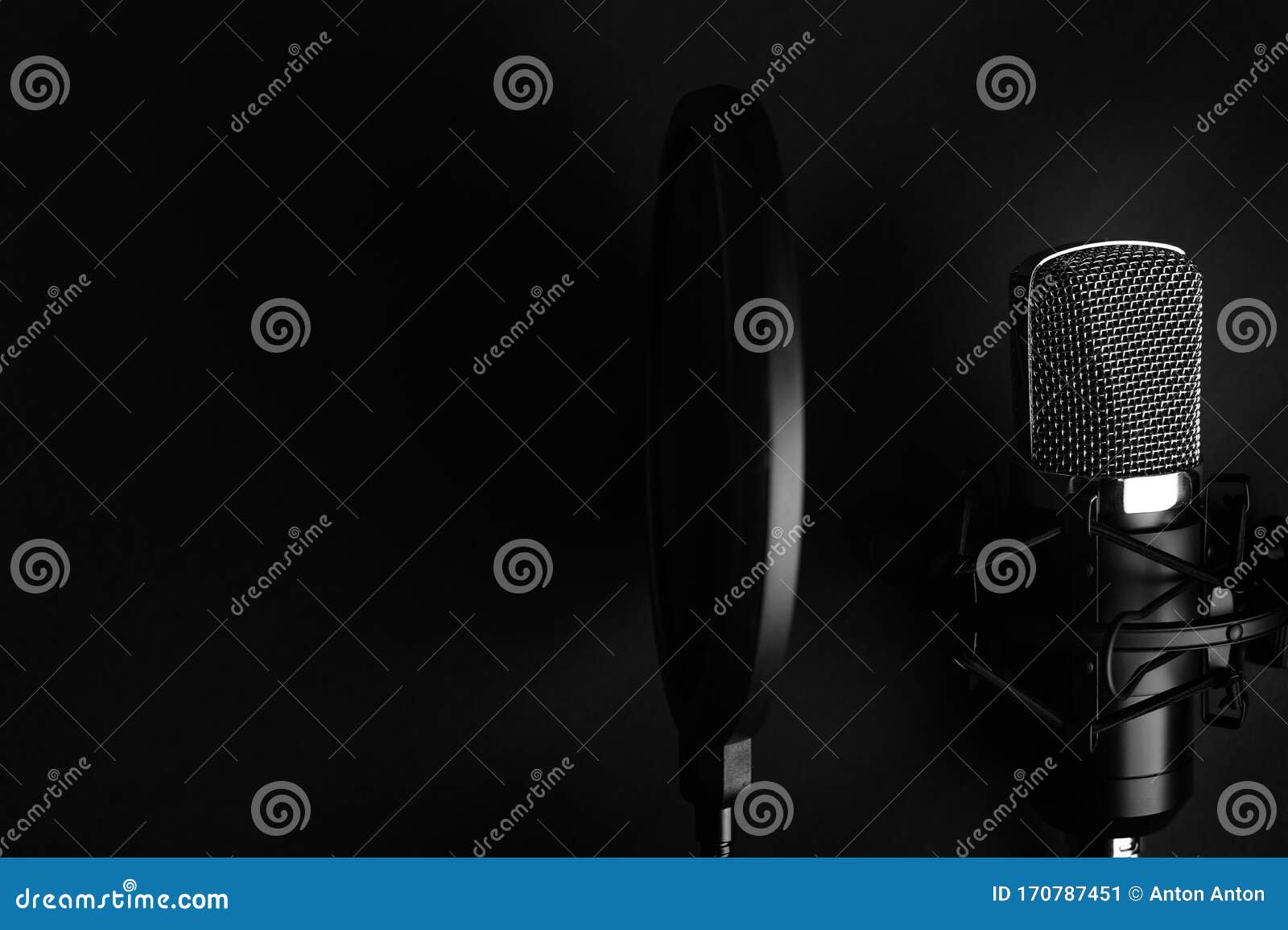 Black Studio Microphone on a Black Background with a Pop Filter with ...