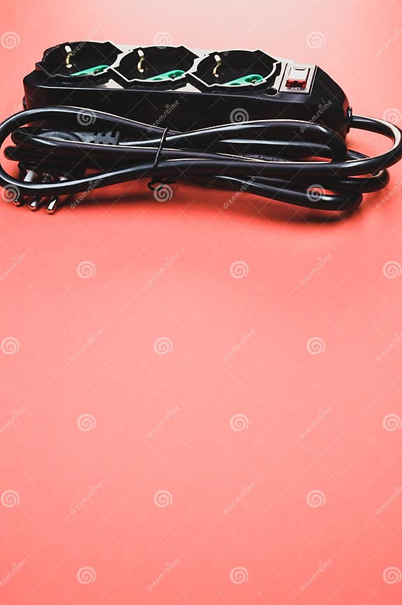 Black Surge Protector on a Light Red Background Stock Image - Image of ...