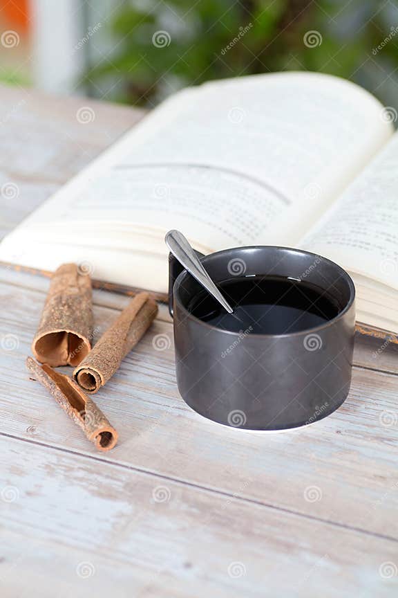 Black tea and opened book stock image. Image of composition - 228938785