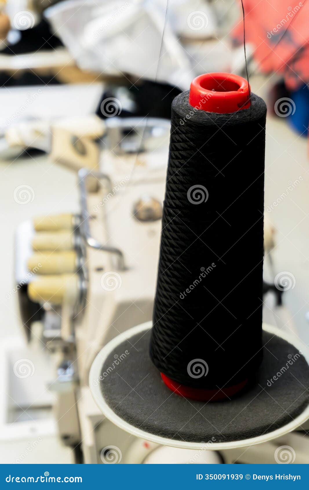 Black Thread Spool on a Sewing Machine in a Bright Workshop Stock Image ...