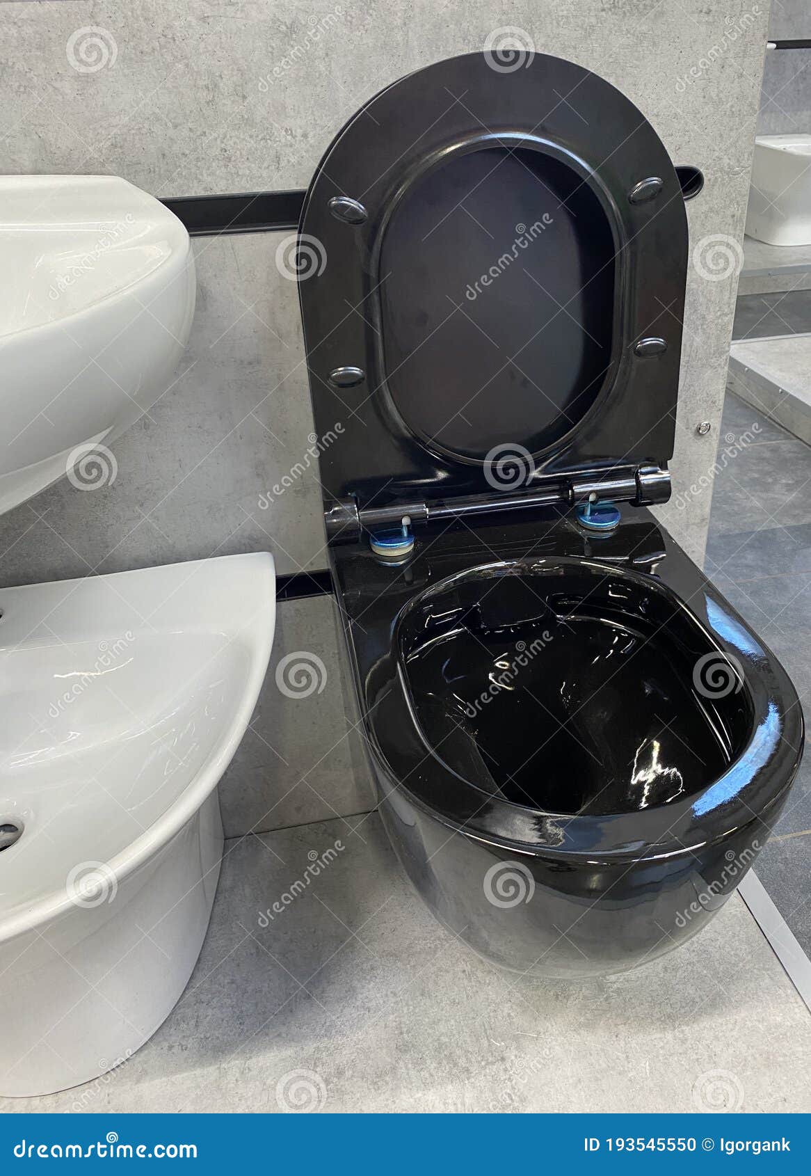 A Black Toilet Next To a White Sink Stock Photo - Image of sink, toilet ...