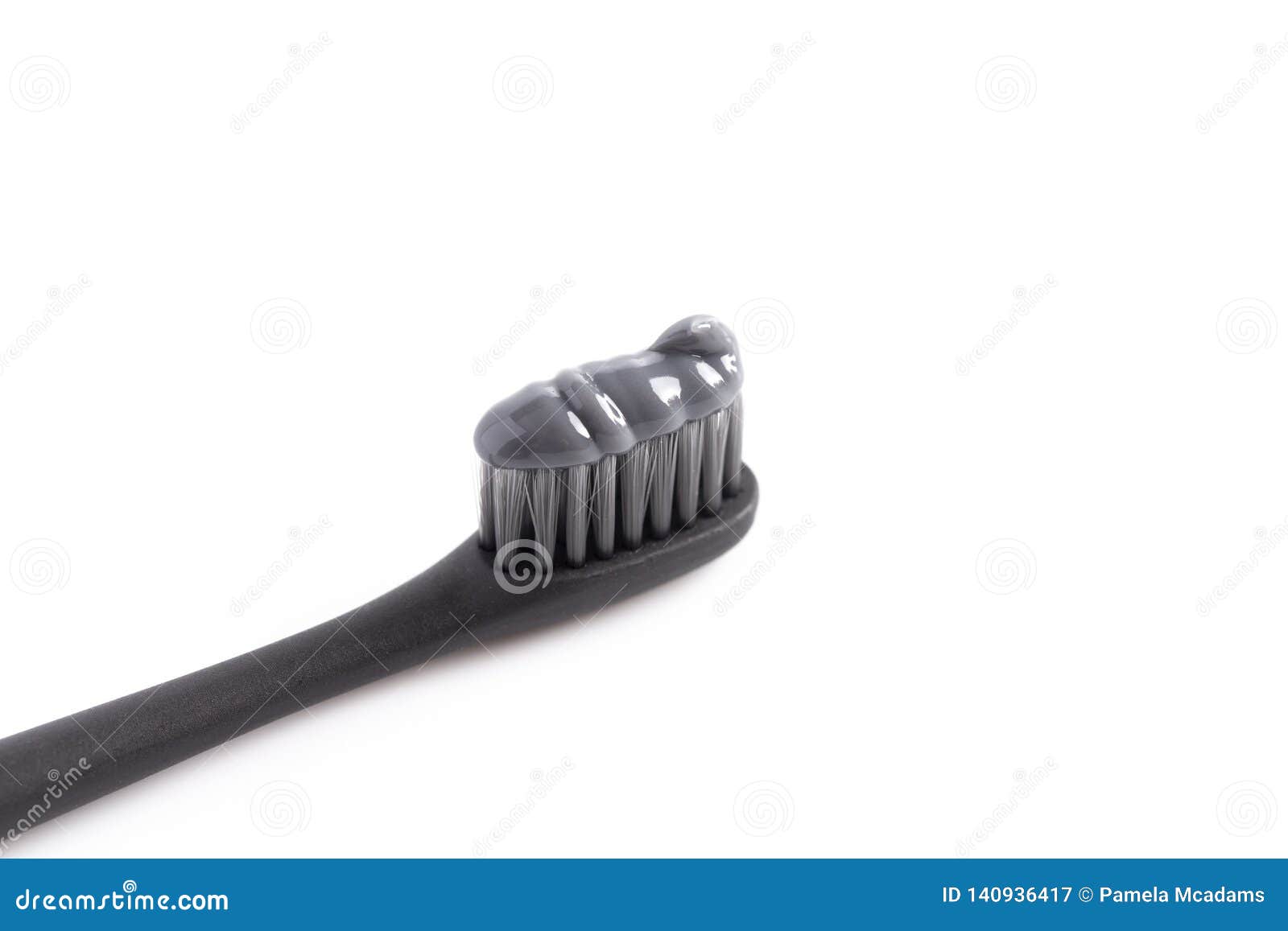 A Black Toothbrush with Black Activated Charcoal Toothpaste on a White ...