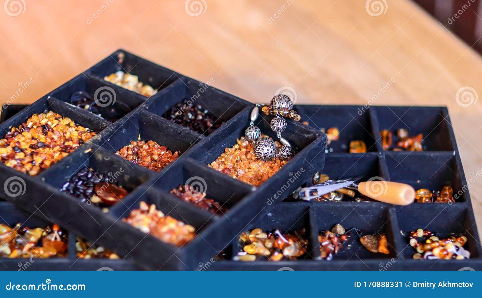 A Black Tray for Handcrafting with Multiple Sections Filled with ...