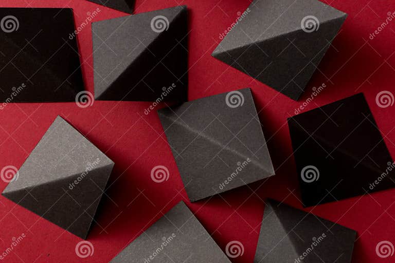 Black Triangle Shapes on Red Background, Top View Stock Photo - Image ...