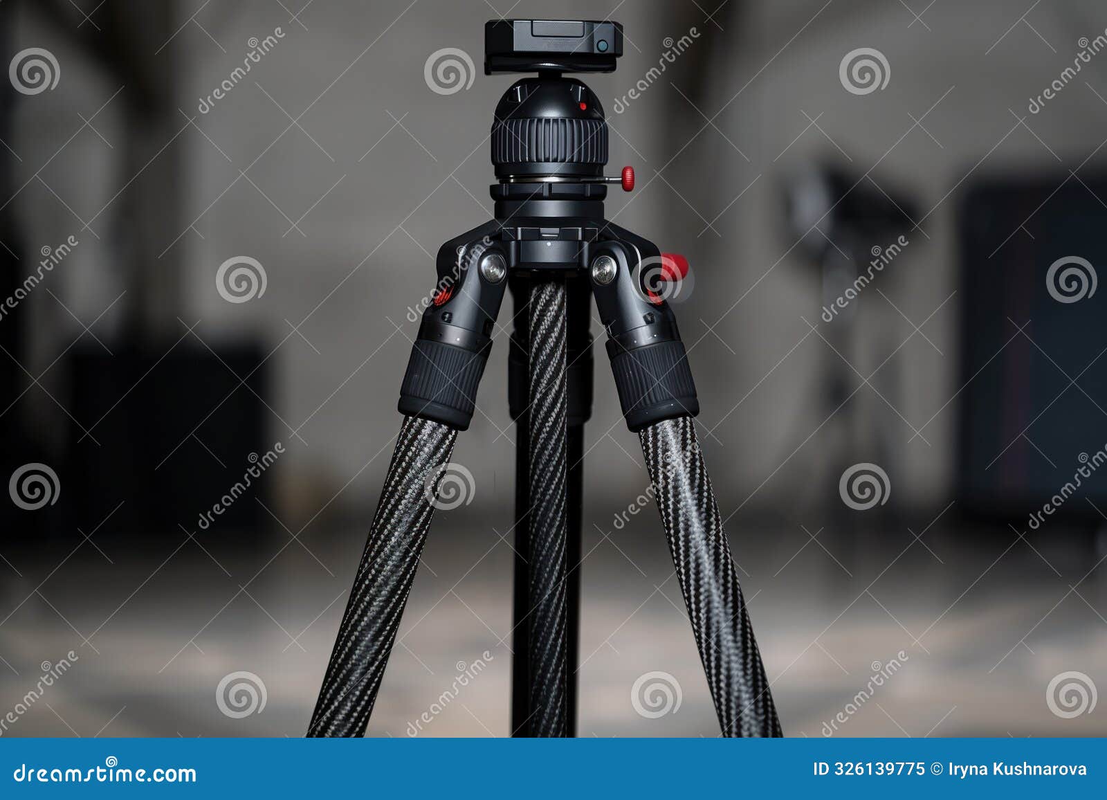 Black Tripod Stands on Left Side of Frame with Tilted Top Leg. Middle ...