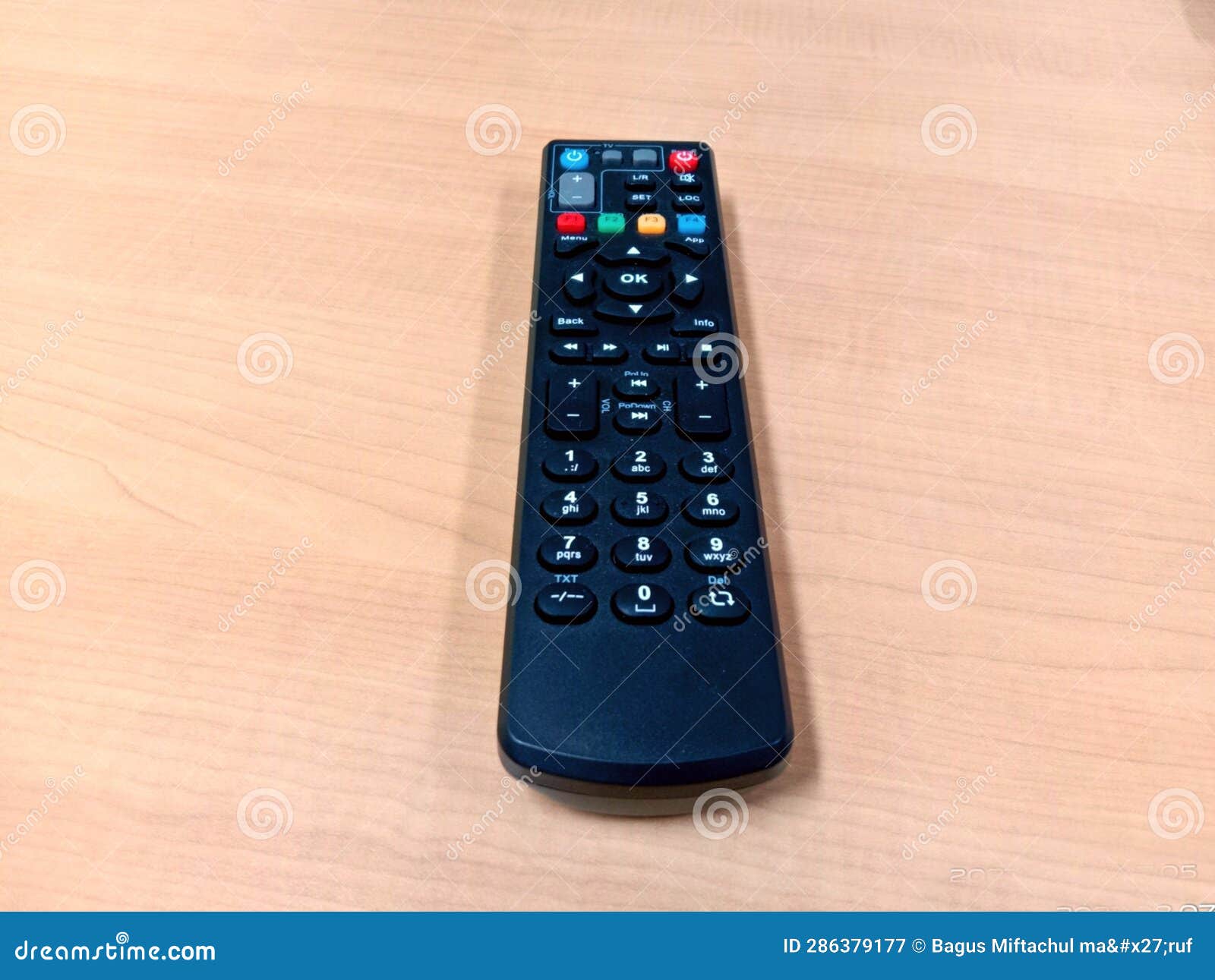 A Black TV Remote on a Brown Table Stock Image - Image of office ...