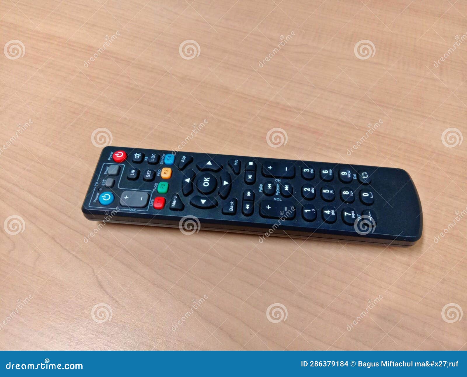 A Black TV Remote on a Brown Table Stock Photo - Image of entertainment ...