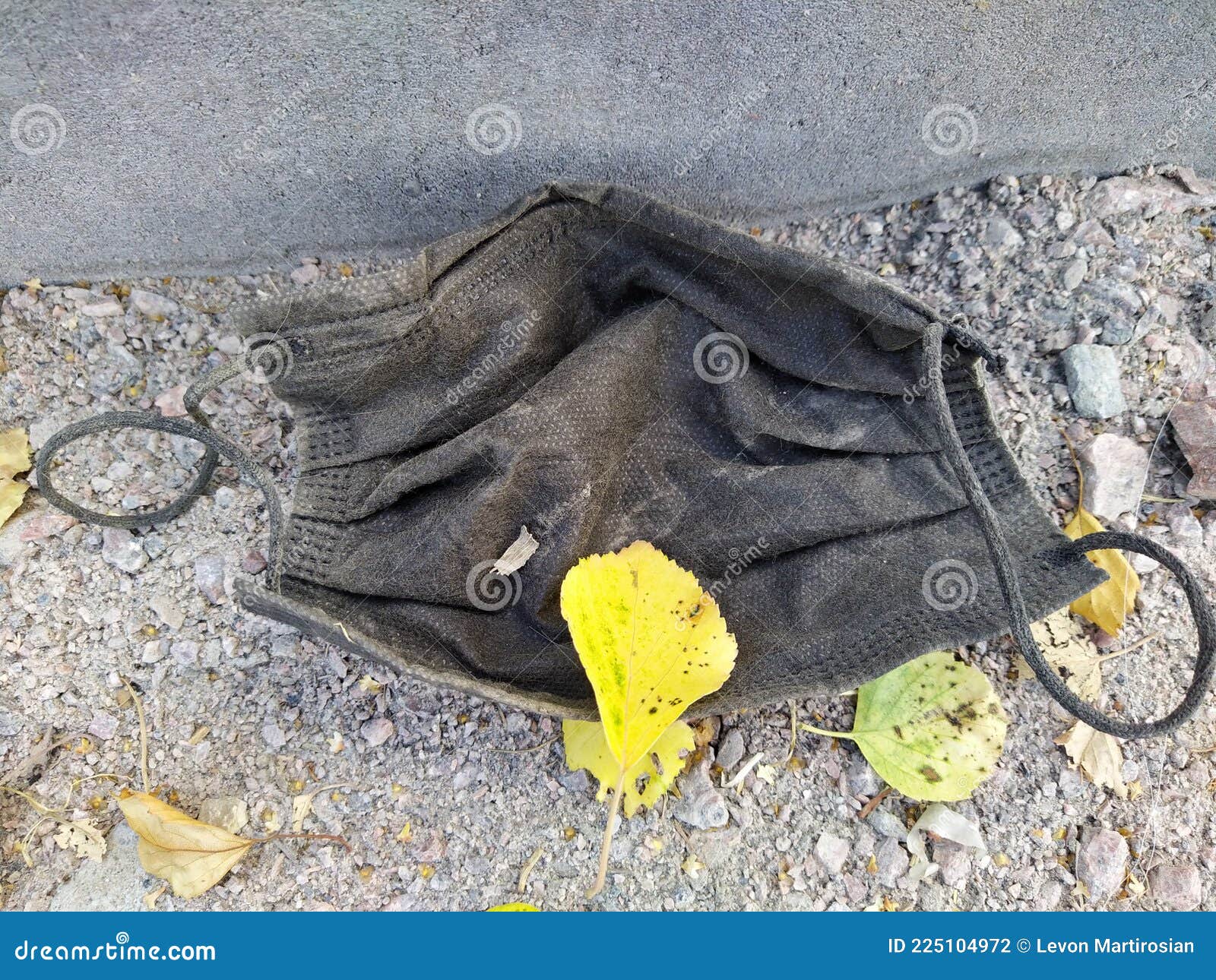 Black Used Mask Thrown Out into the Street. Stock Photo - Image of ...