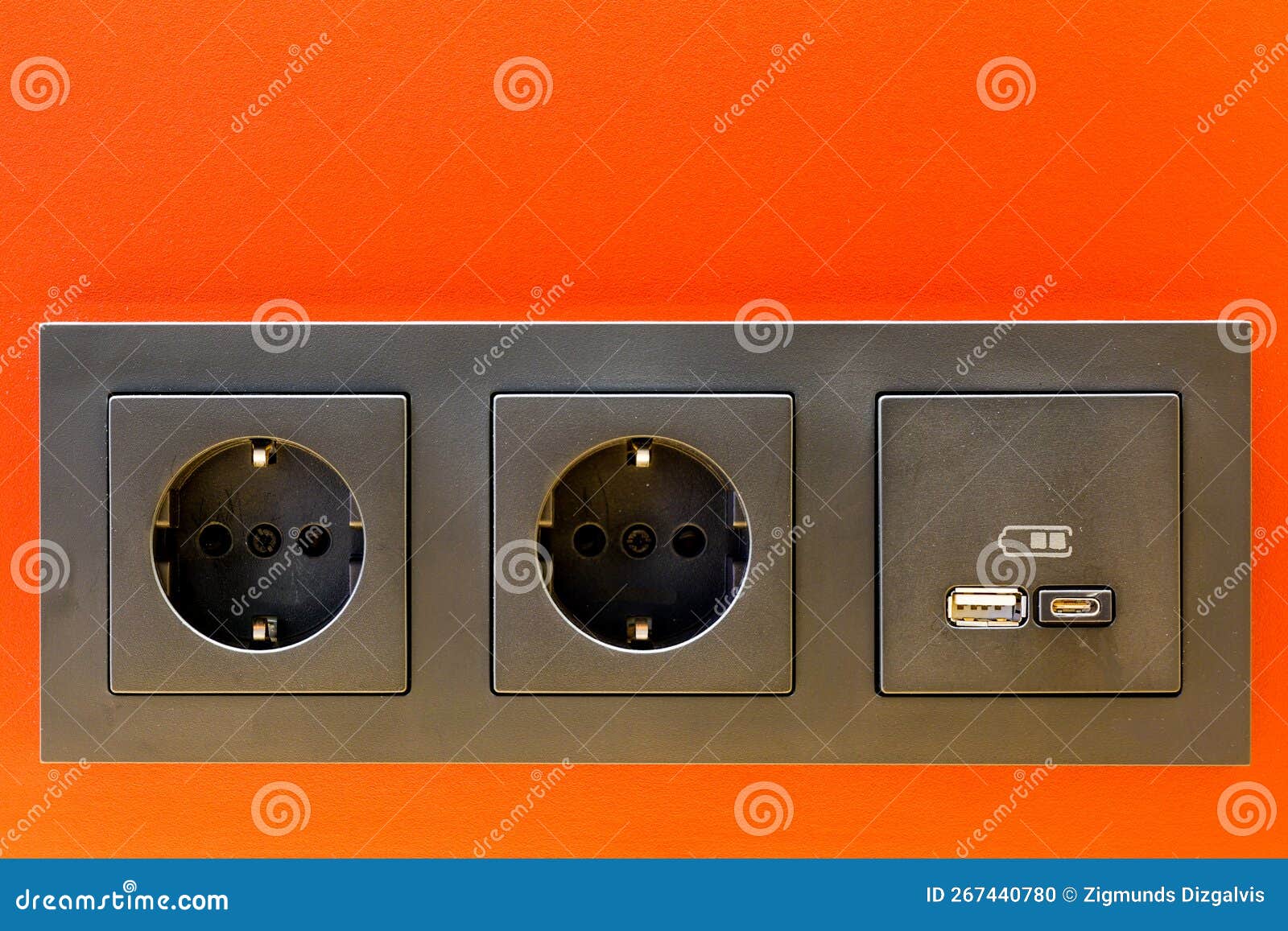A Black 220V, USB and USB C Socket Block is Built into the Orange Wall ...
