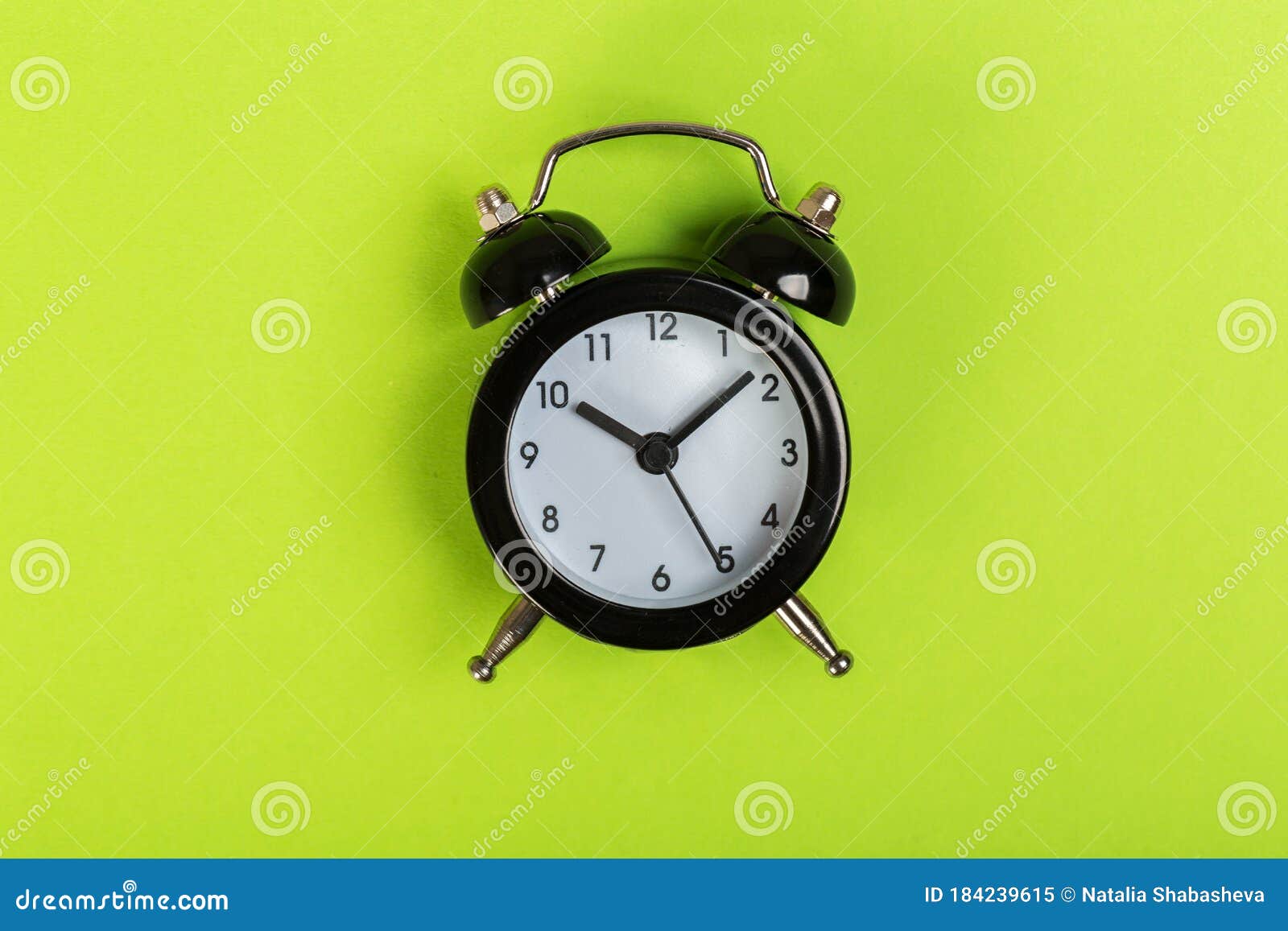 Black Vintage Alarm Clock on a Colored Background, Top View. Concept of ...