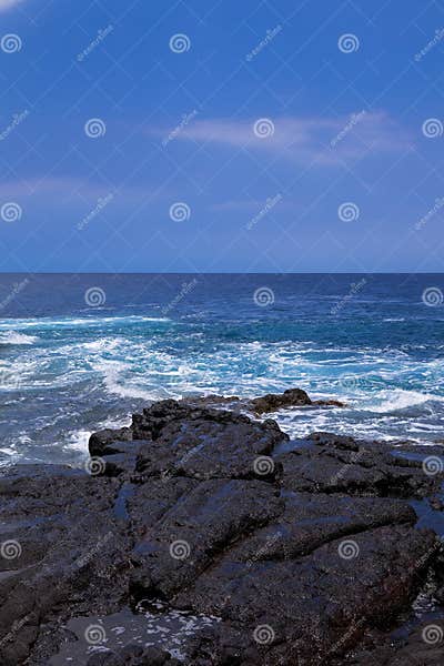 Black Volcanic Rocks on Ocean Shore Stock Photo - Image of blue, nature ...