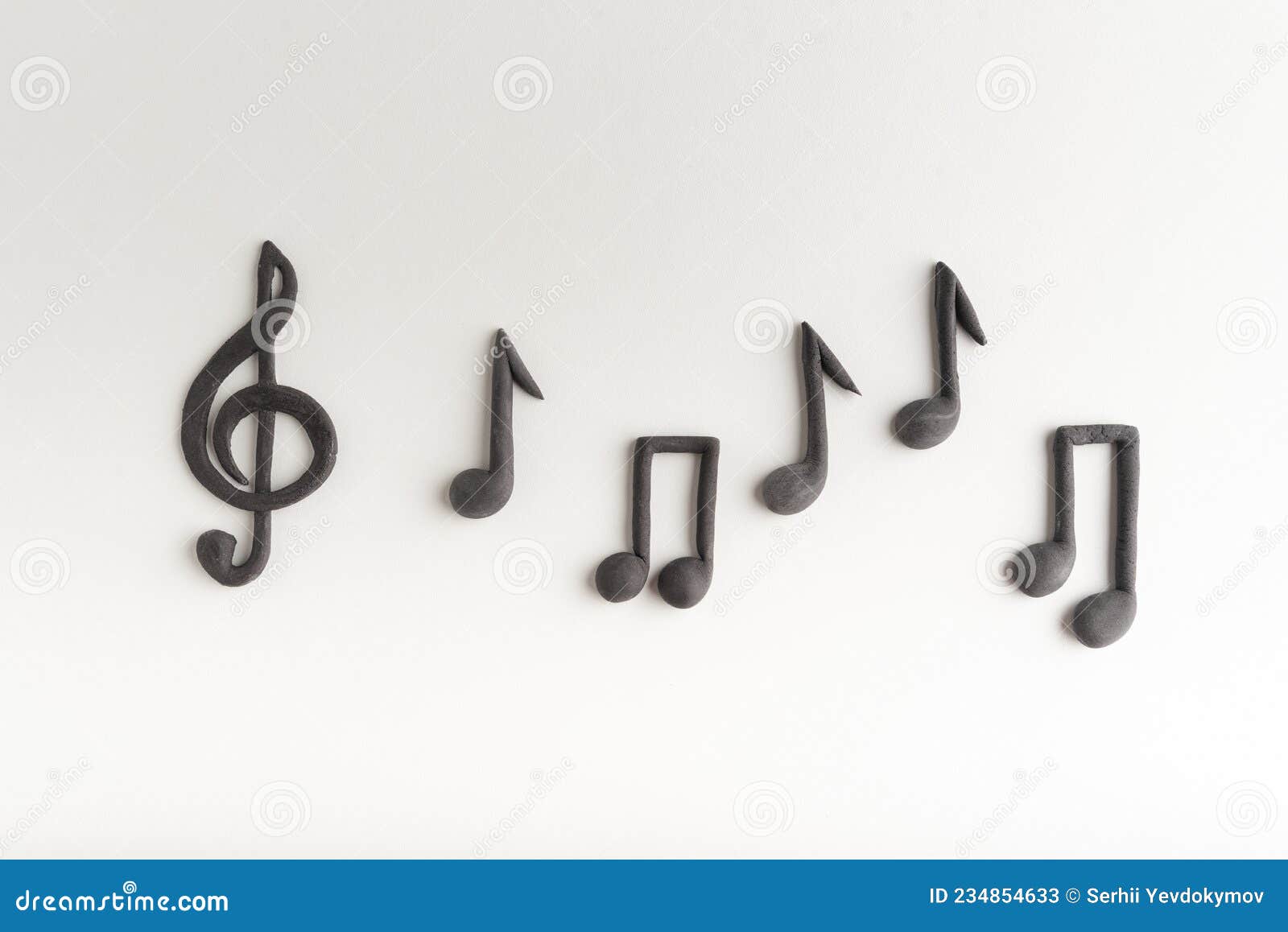 Black Volumetric Notes and Violin Key on White Background Top View ...