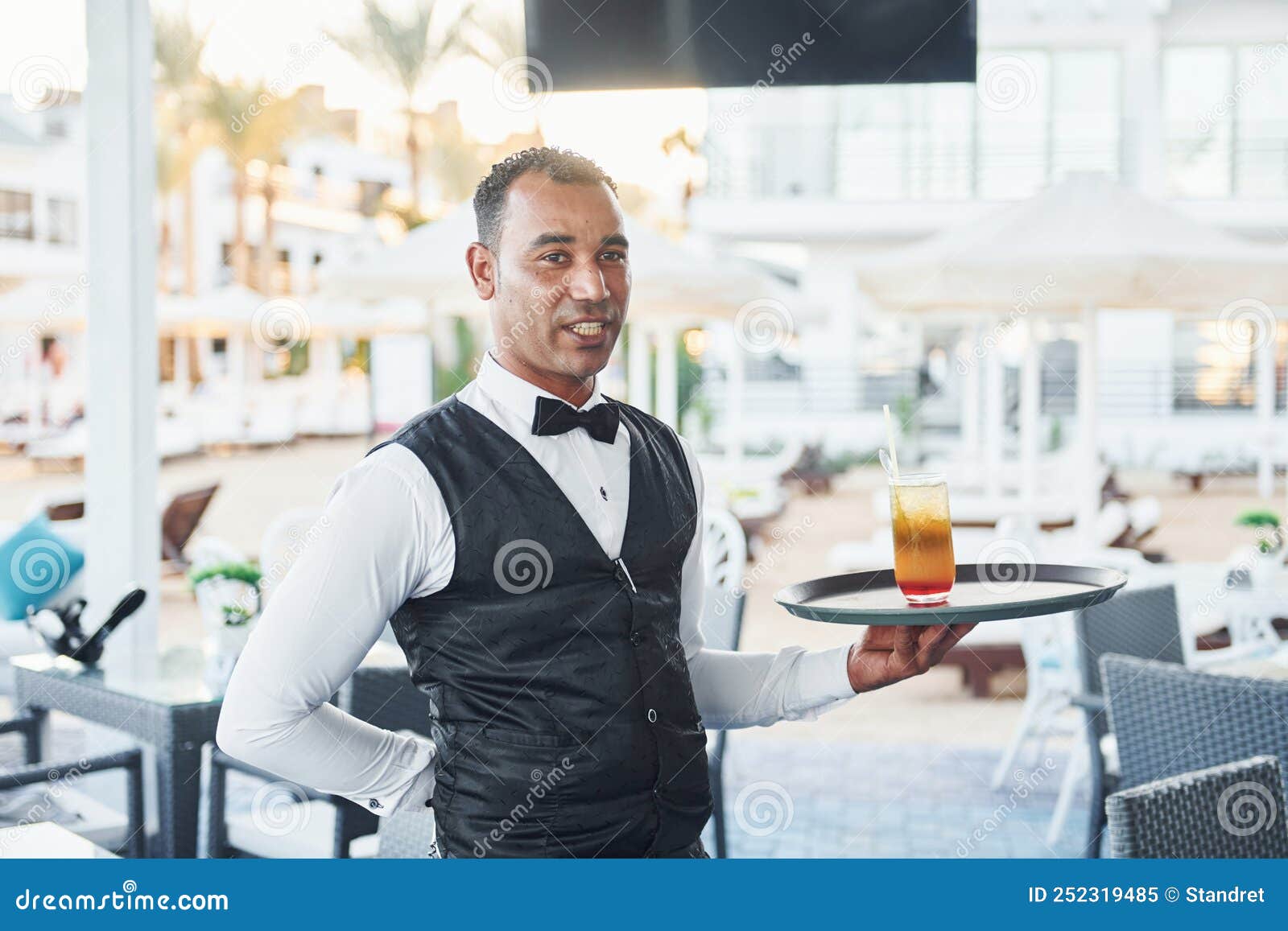 Black Waiter in Formal Clothes is at His Work Outdoors at Sunny Daytime ...